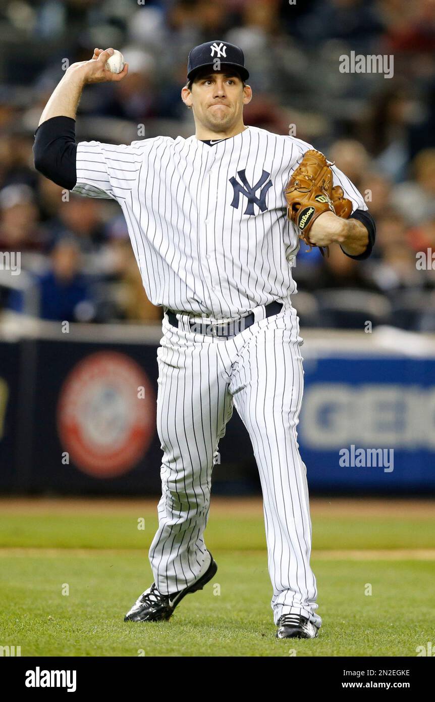 New York Yankees starting pitcher Nathan Eovaldi (30) throws to first ...