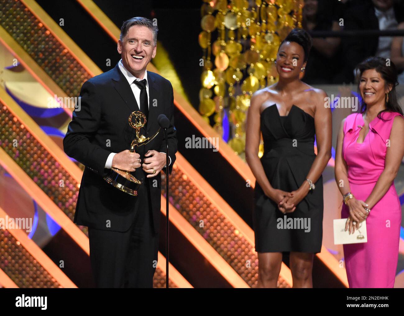 Craig Ferguson, left, accepts the award for outstanding game show host ...