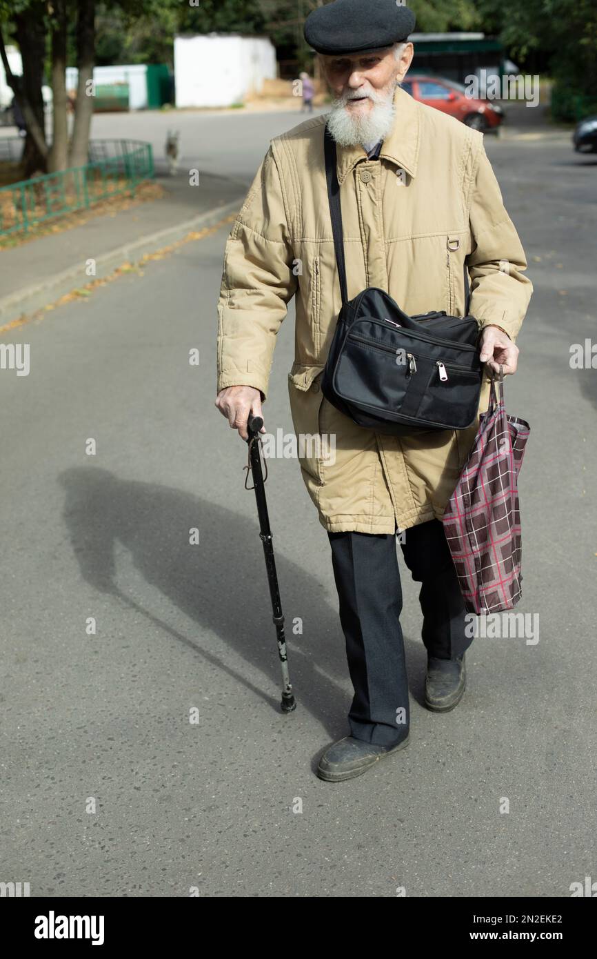 Old man with walking stick hi-res stock photography and images - Alamy