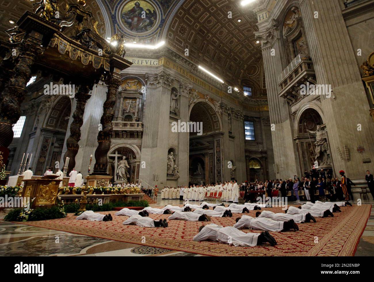 Nineteen new priests lay on the ground during a ceremony in which Pope ...
