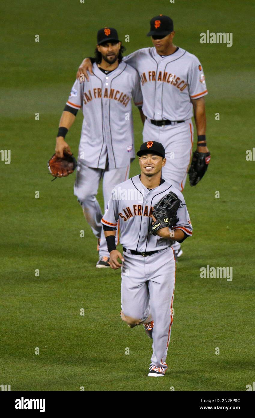 San Francisco Giants left fielder Nori Aoki, front, smiles as he runs ...