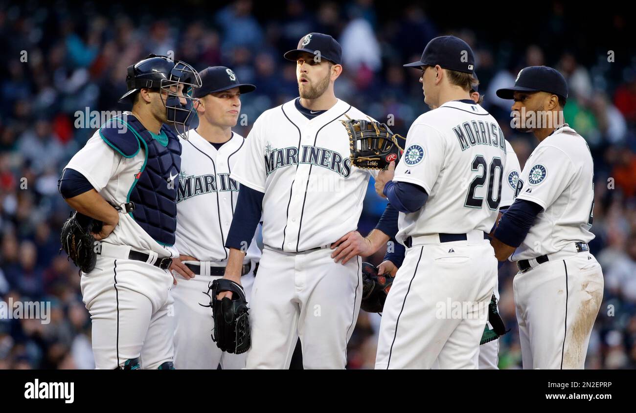 Seattle Mariners starting pitcher James Paxton, center, waits with ...