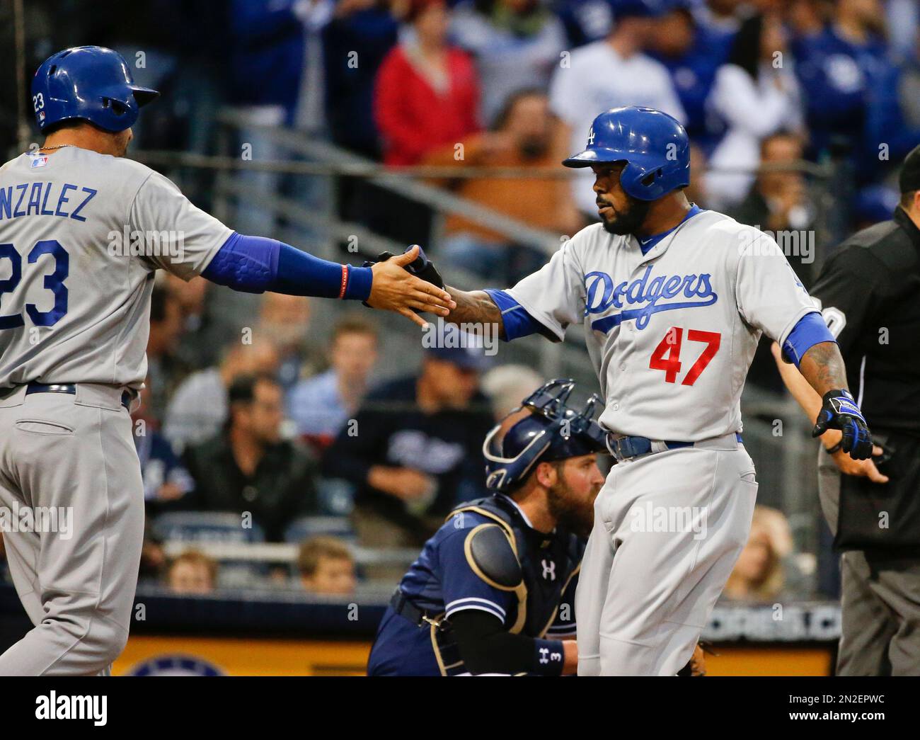 Los Angeles Dodgers' Howie Kendrick is greeted by Adrian Gonzalez after ...