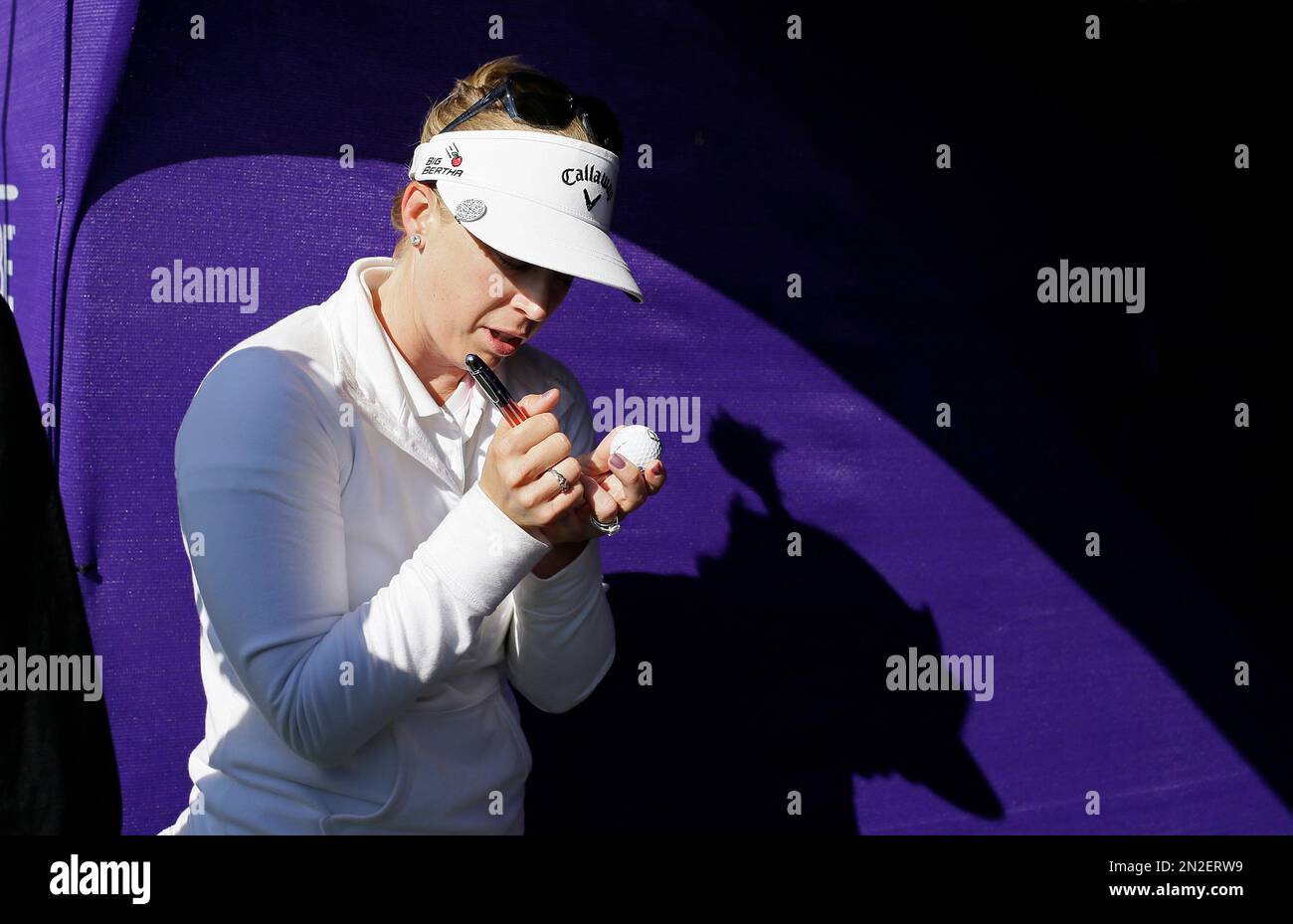 Morgan Pressel signs a golf ball off the 18th green of the Lake Merced ...