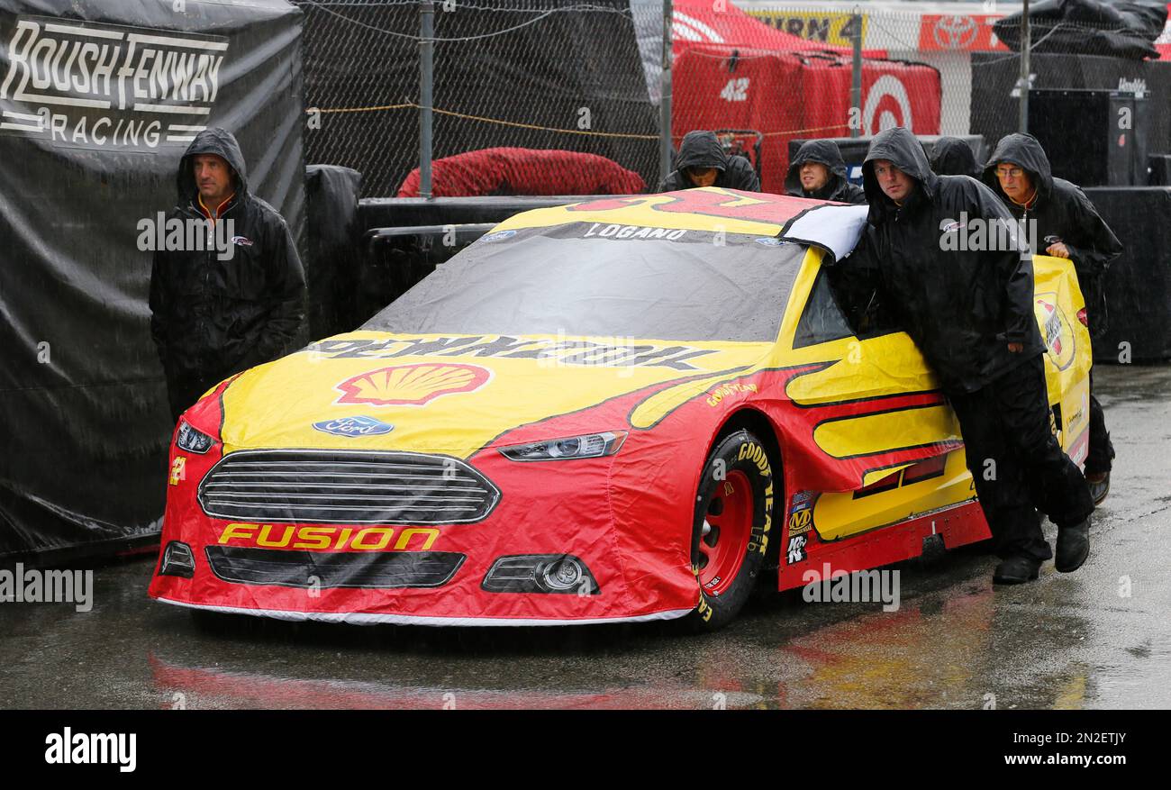 The pit crew for Joey Logano (22) push the car in the inspection line ...
