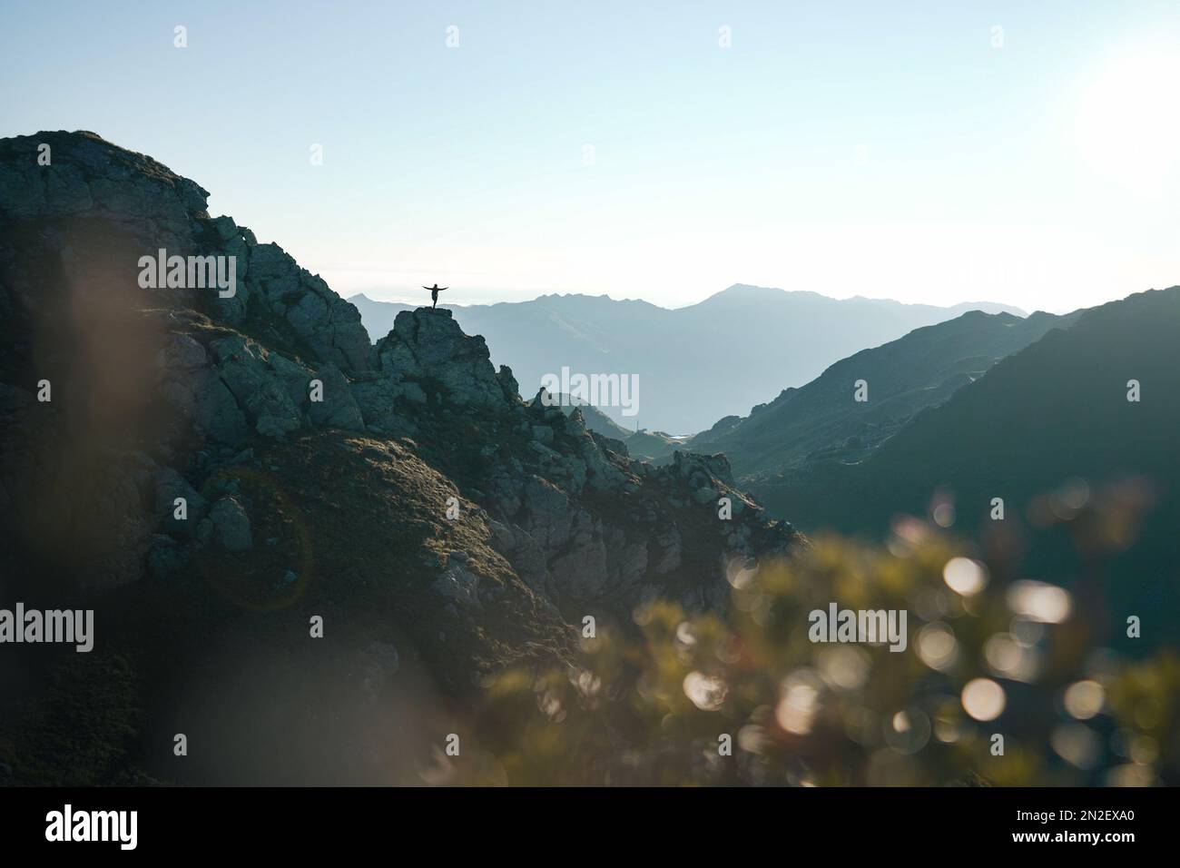 An aerial view of person standing at the edge of cliff Stock Photo - Alamy