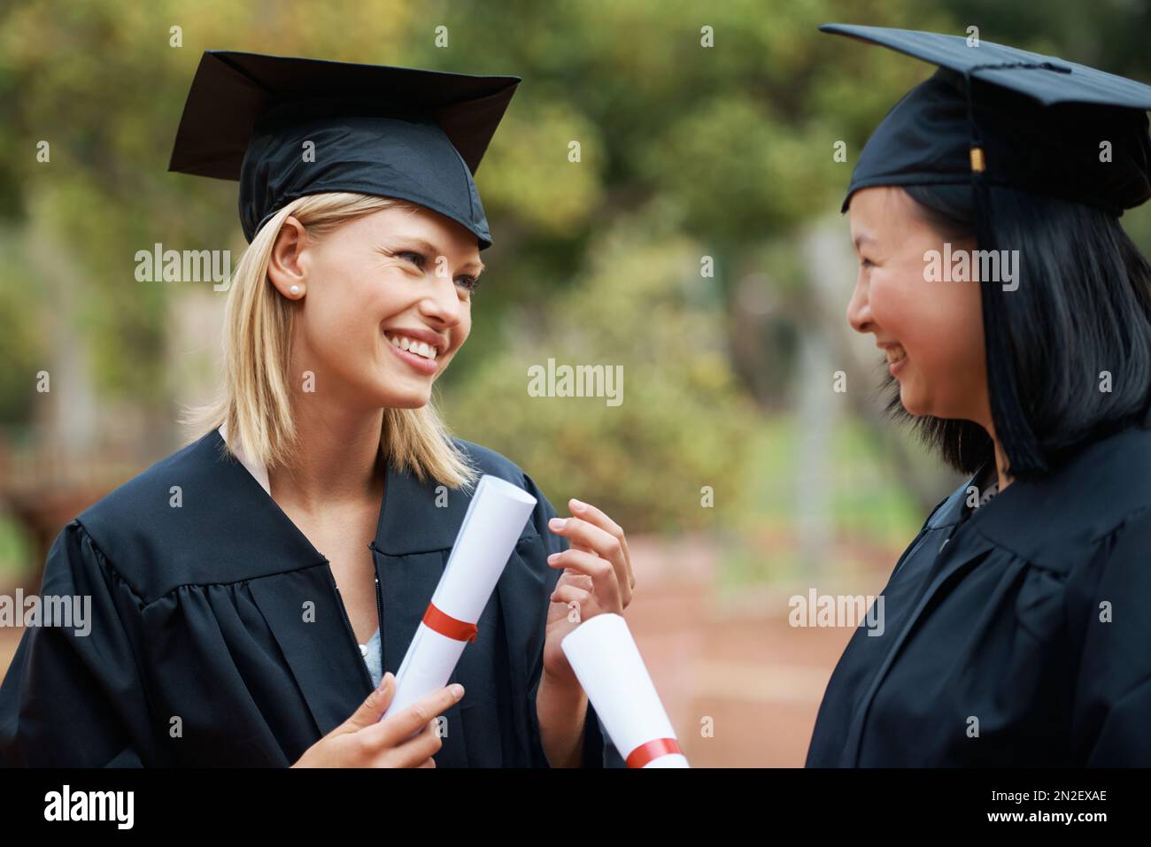 Weve finally graduated. Two young college graduates holding their ...