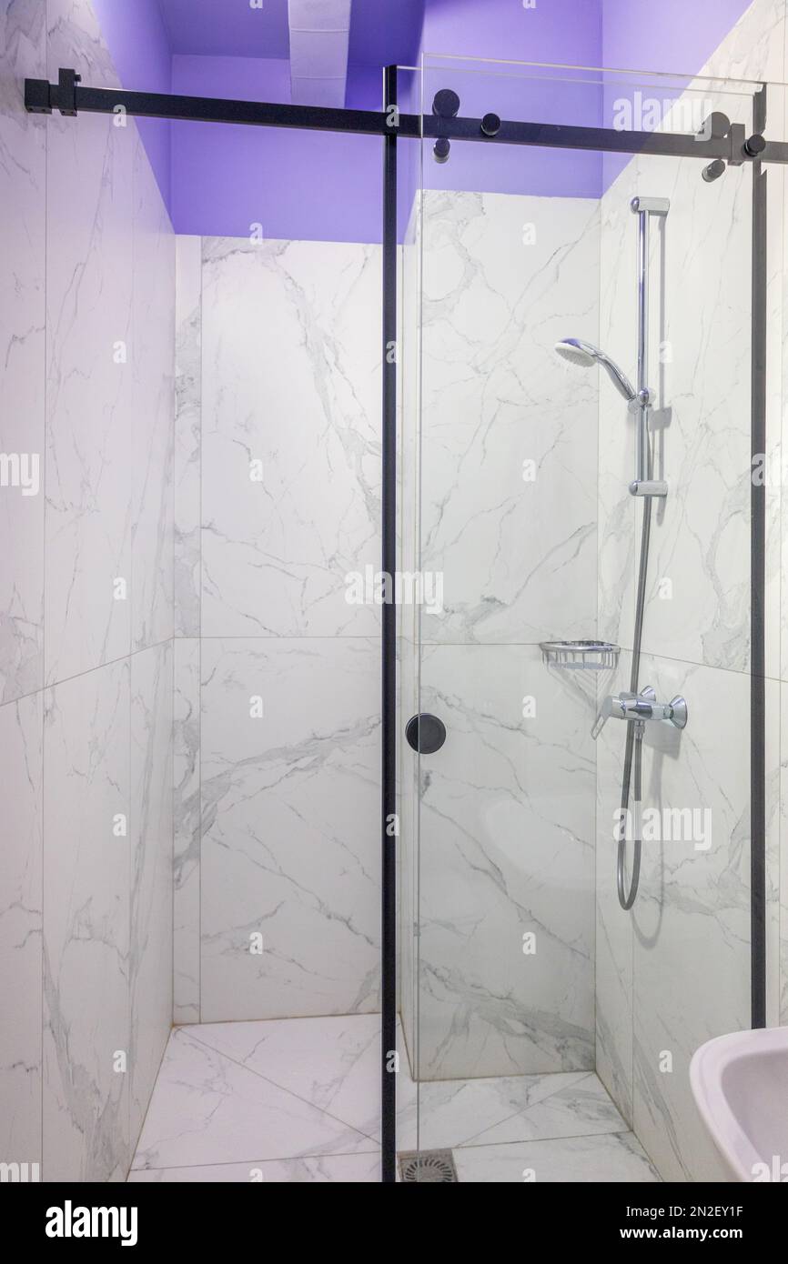 Fresh shower behind wet glass window. Jets of clean water flowing from ...