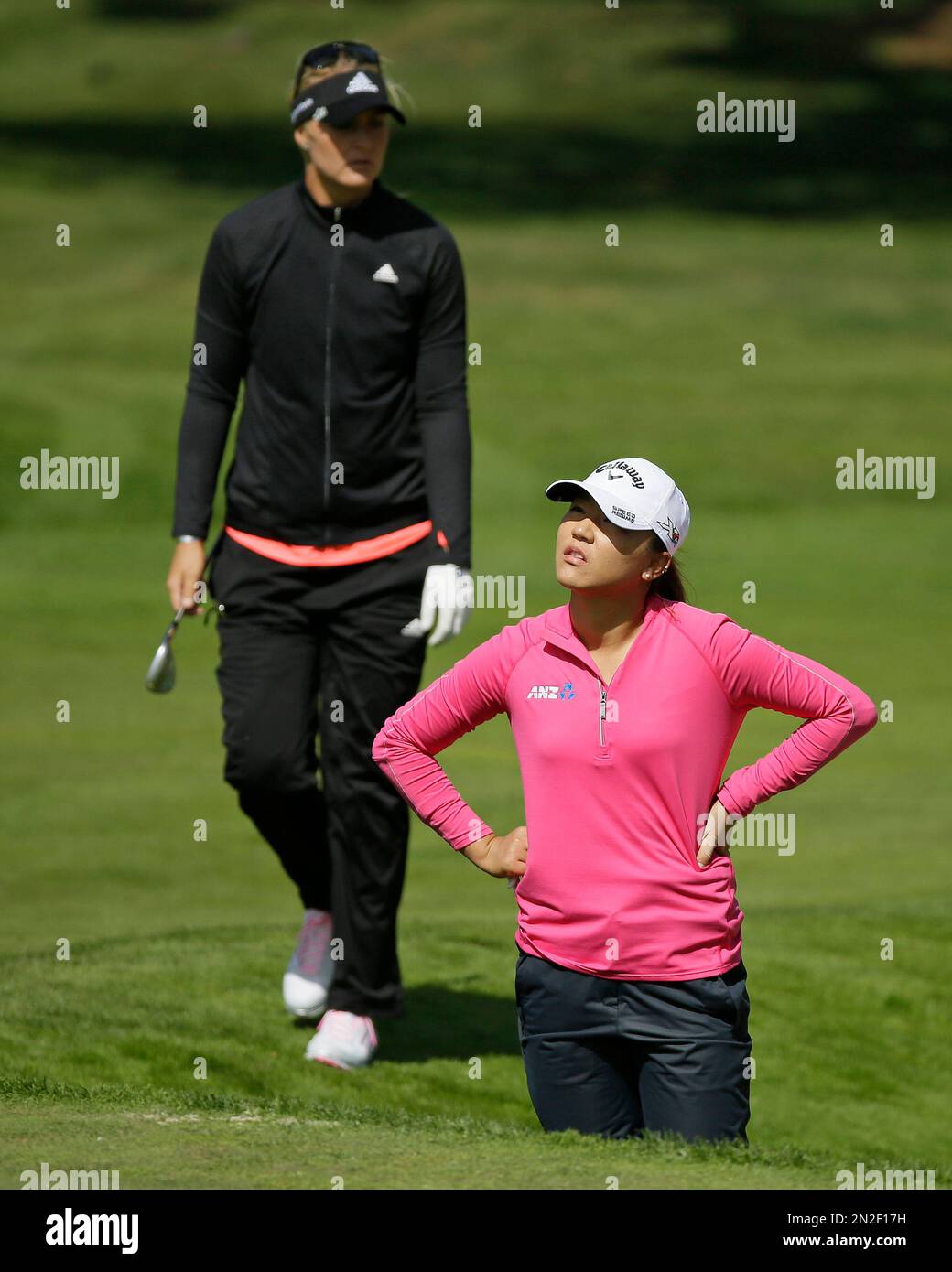 Lydia Ko of New Zealand, right, listens to her caddy before hitting ...