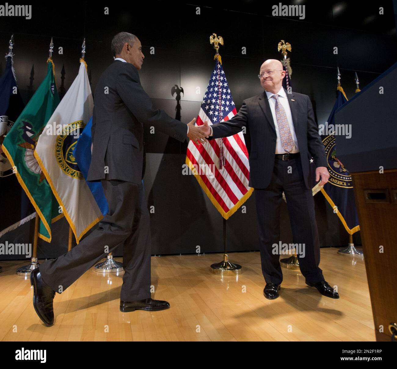President Barack Obama shakes hands with Director of National ...