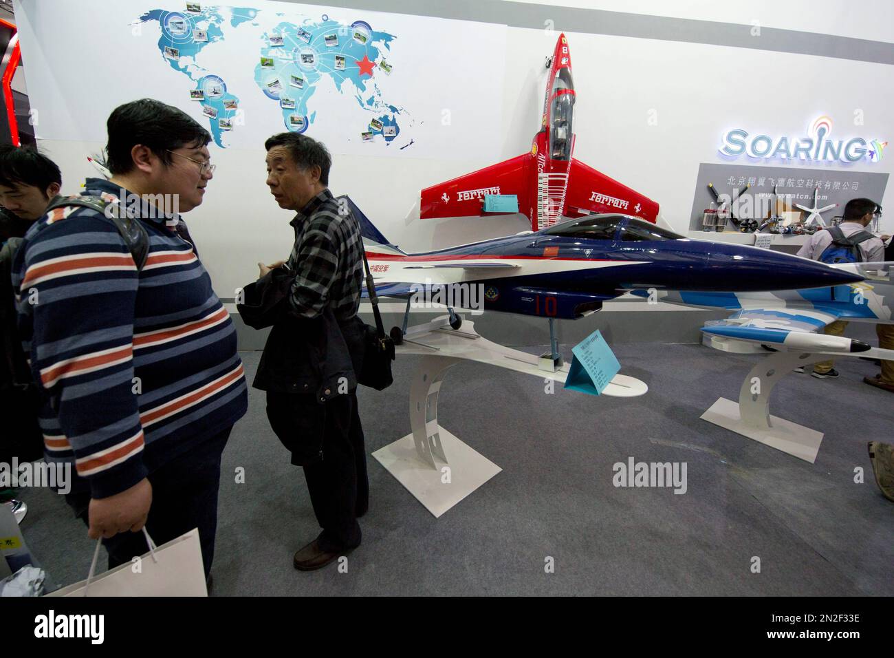 Visitors to the China Hobby Expo walk by remote control planes on ...