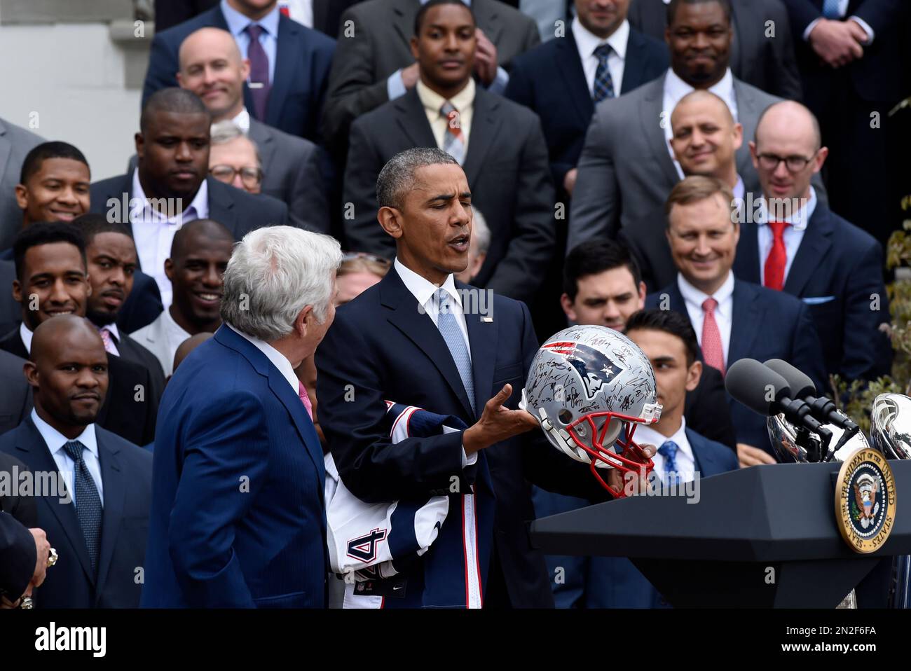 President Barack Obama holds a signed New England Patriots football ...