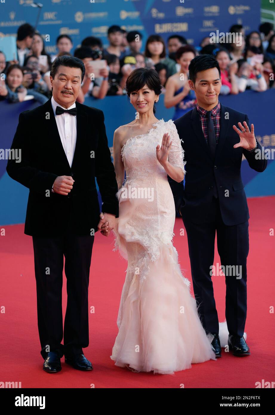 Hong Kong actress Angie Chiu, center, walks with her husband Melvin Wong, left, and her son ...