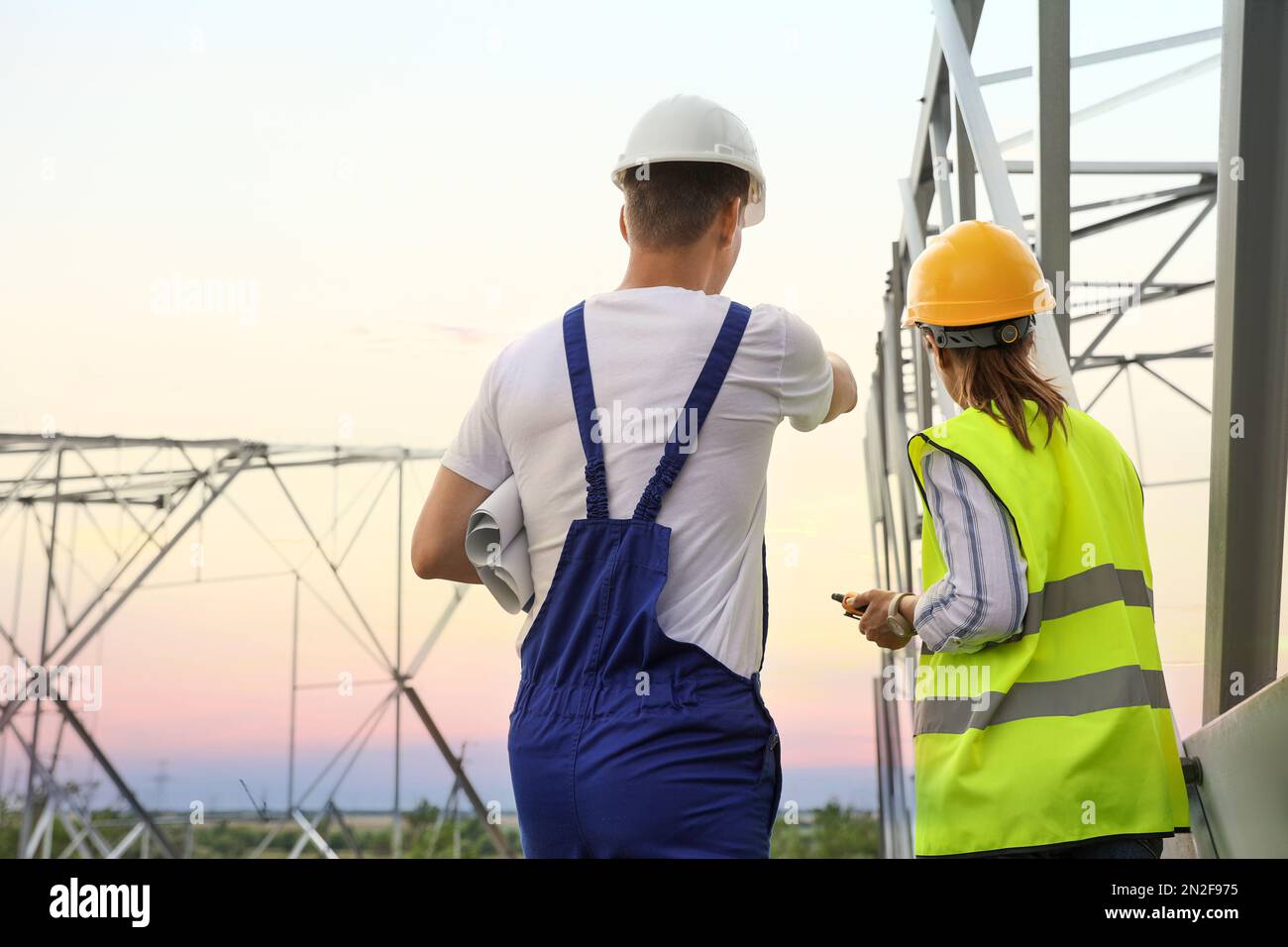 Professional engineers working on installation of electrical substation ...
