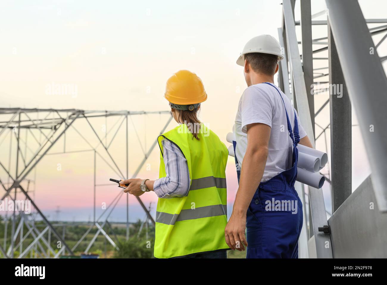 Professional engineers working on installation of electrical substation ...