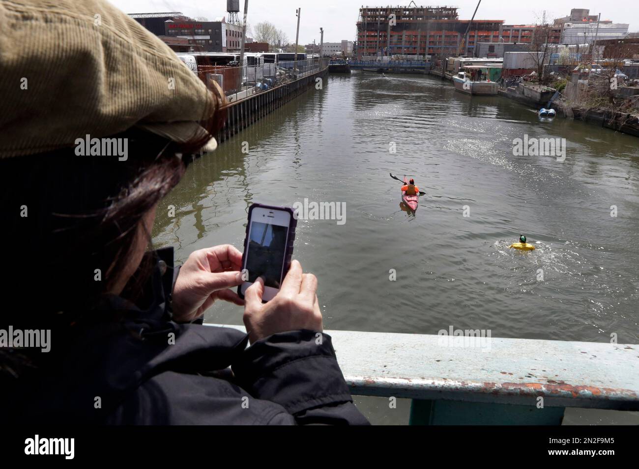 People watch from a bridge as clean-water advocate Christopher Swain ...
