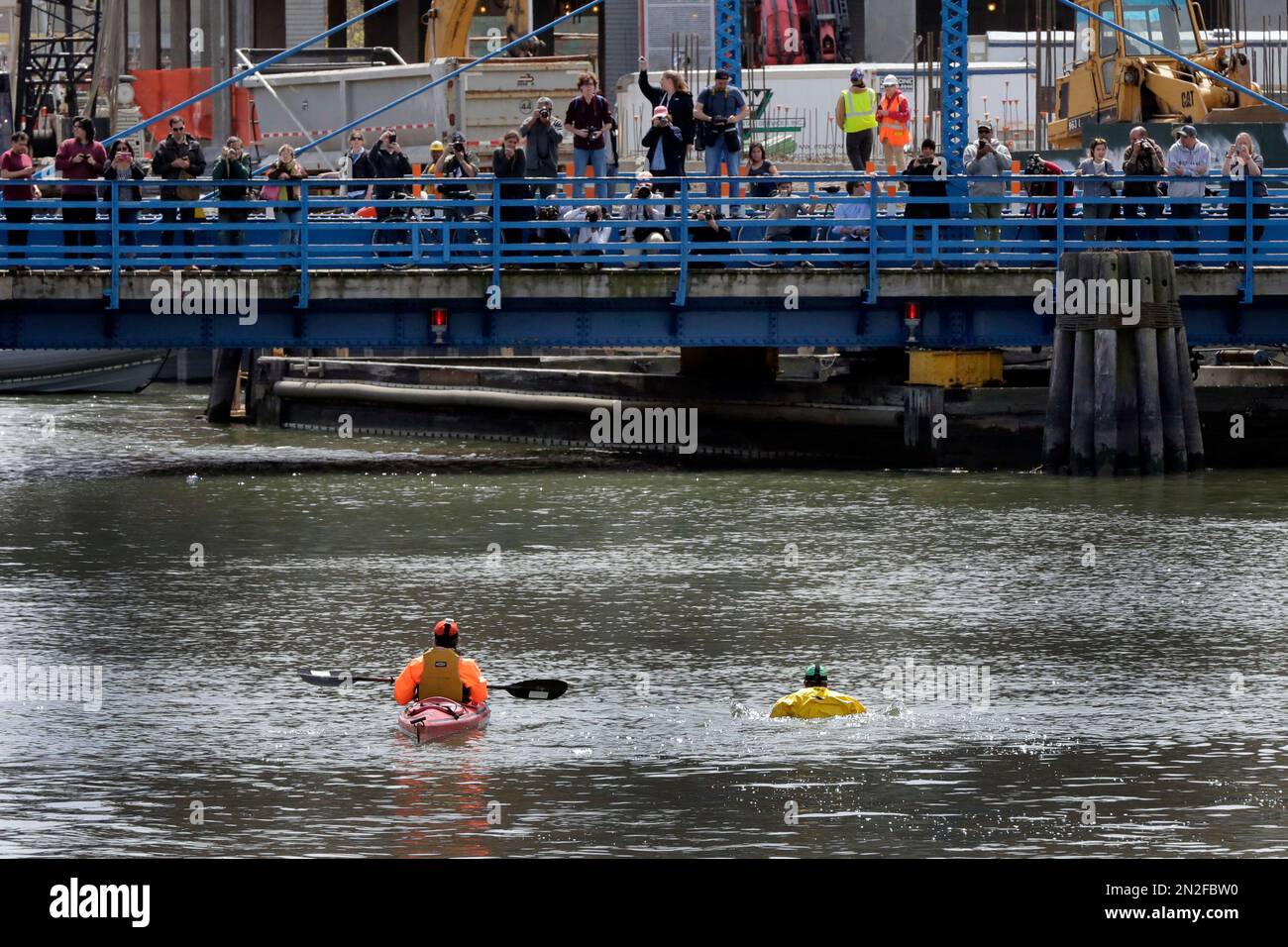 People watch from a bridge as clean-water advocate Christopher Swain ...