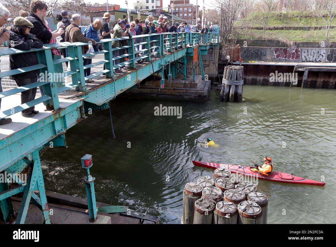 People watch from a bridge as clean-water advocate Christopher Swain ...