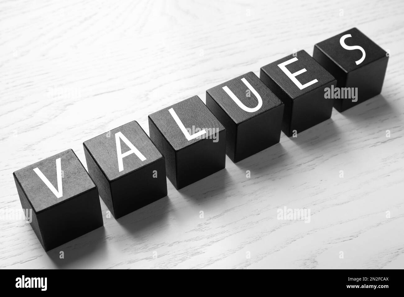 Black cubes with word VALUES on white wooden background Stock Photo - Alamy