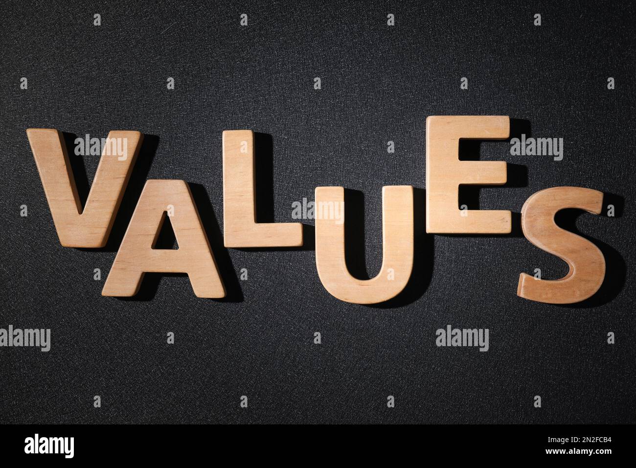 Word VALUES made of wooden letters on black background, flat lay Stock ...