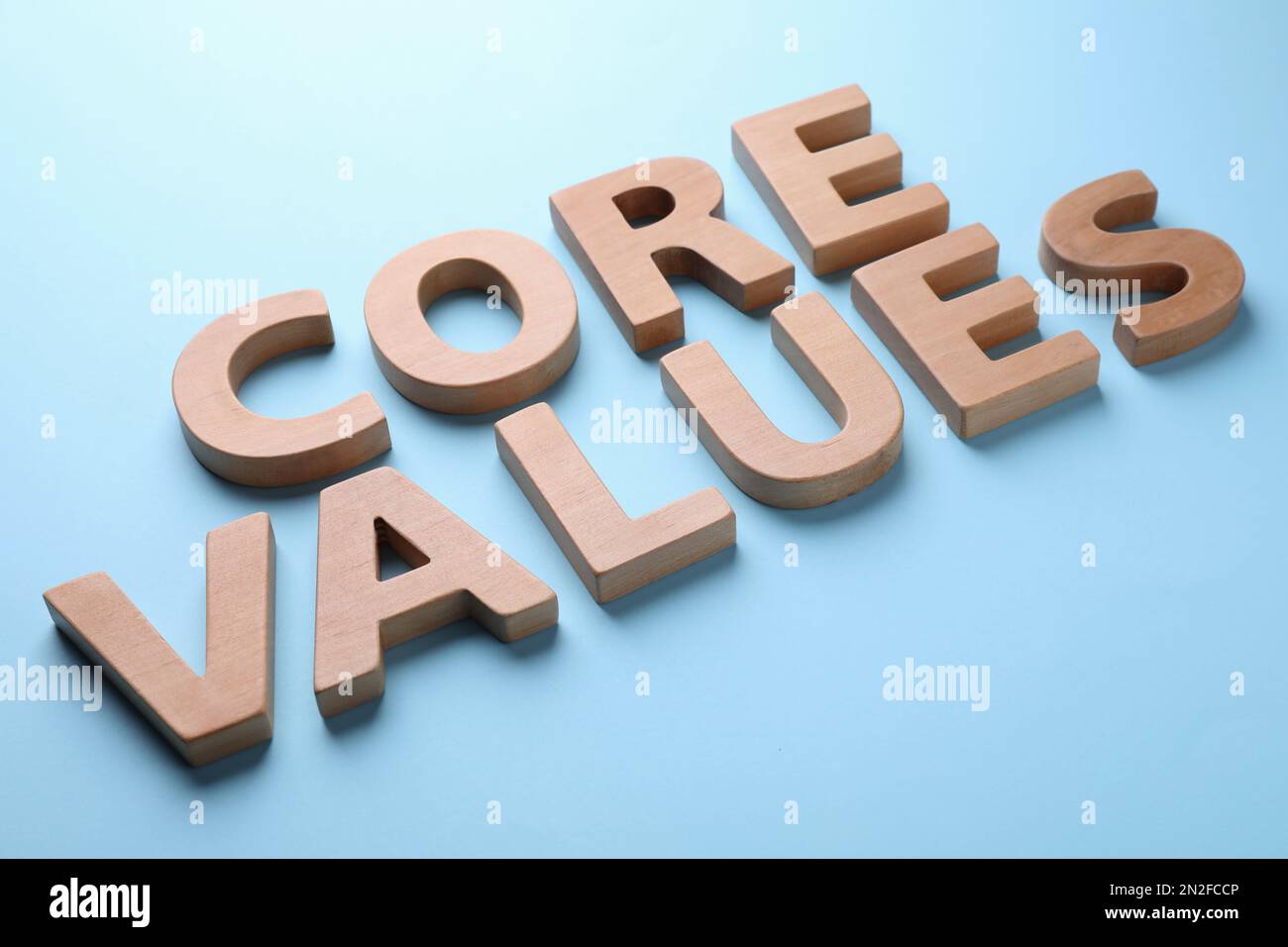 Phrase CORE VALUES made of wooden letters on light blue background ...