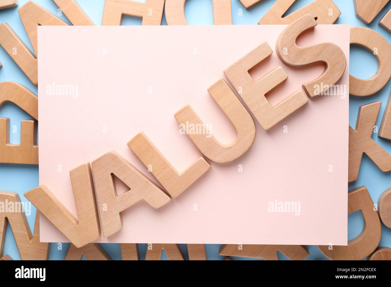 Word VALUES made of wooden letters on light blue background, flat lay ...