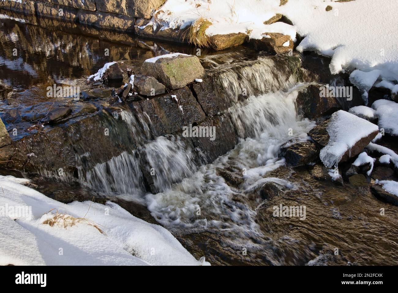 water flowing over stone dam construction Stock Photo - Alamy