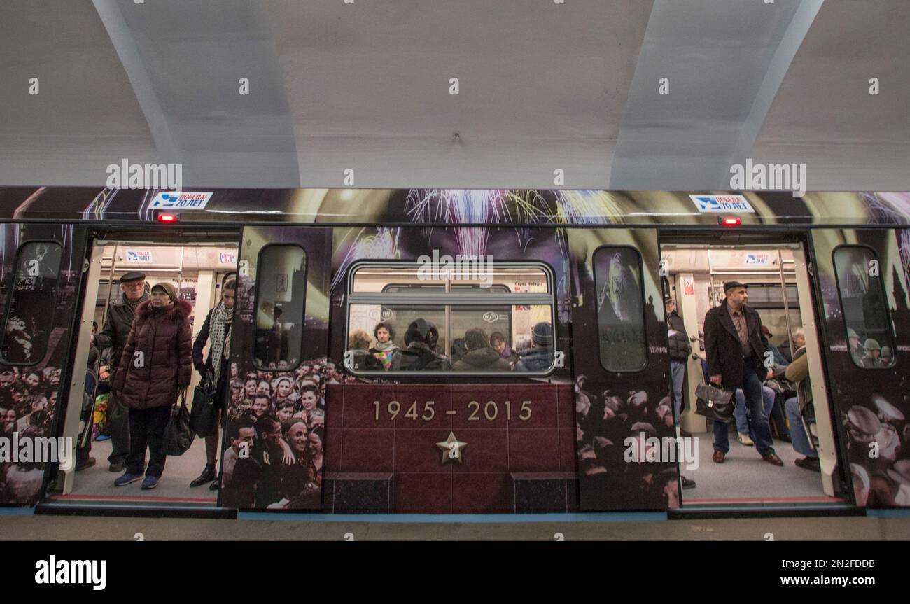 Passengers ride aboard a subway train decorated with World War II era ...