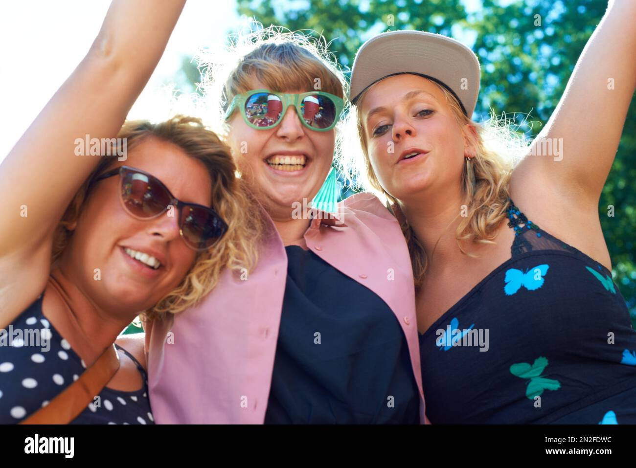 Girls day out. A group of young women having fun at an outdoor festival ...