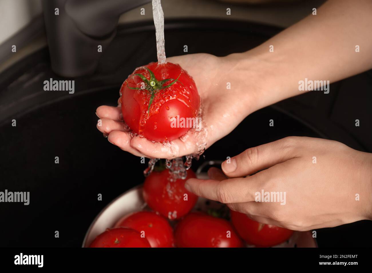 Washing tomatoes in running water hi-res stock photography and images ...