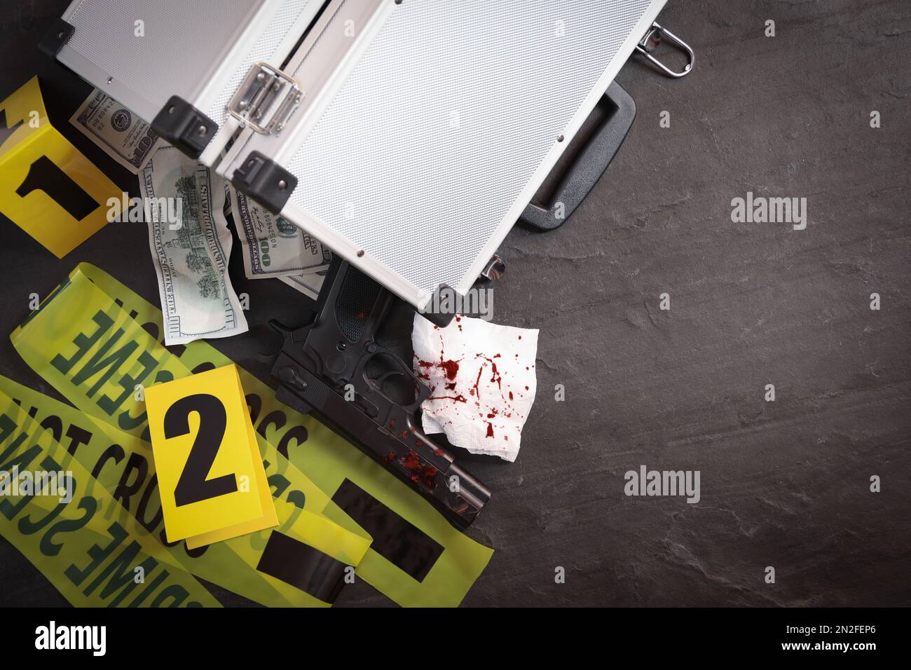 Flat lay composition with evidences and crime scene markers on black ...