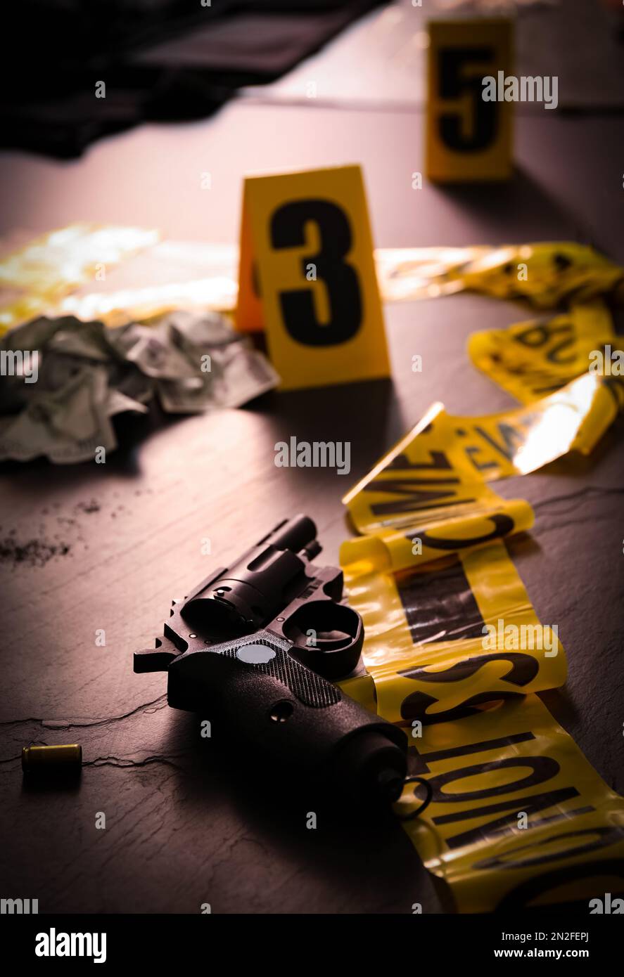 Composition with gun on black slate table, closeup. Crime scene Stock ...