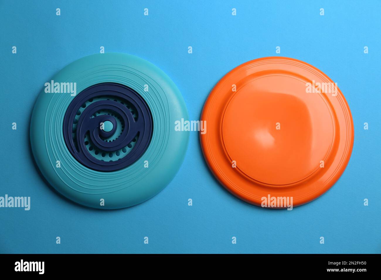 Plastic frisbee disks on light blue background, flat lay Stock Photo ...