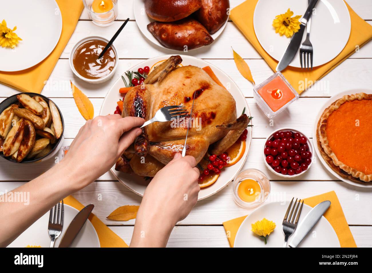 Woman eating traditional cooked turkey at white wooden table, top view ...