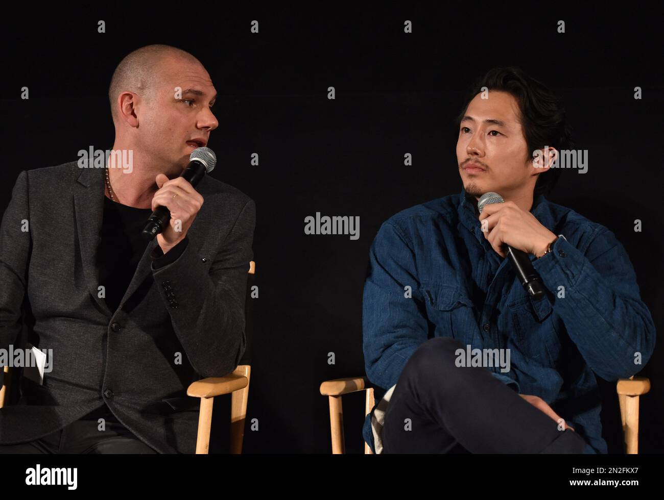 Dominic Patten, left, and Steven Yeun are seen at "The Walking Dead ...