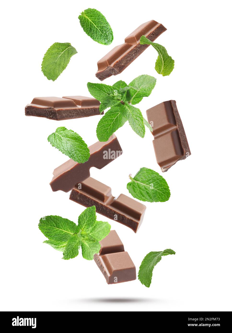Milk chocolate pieces and mint falling on white background Stock Photo ...