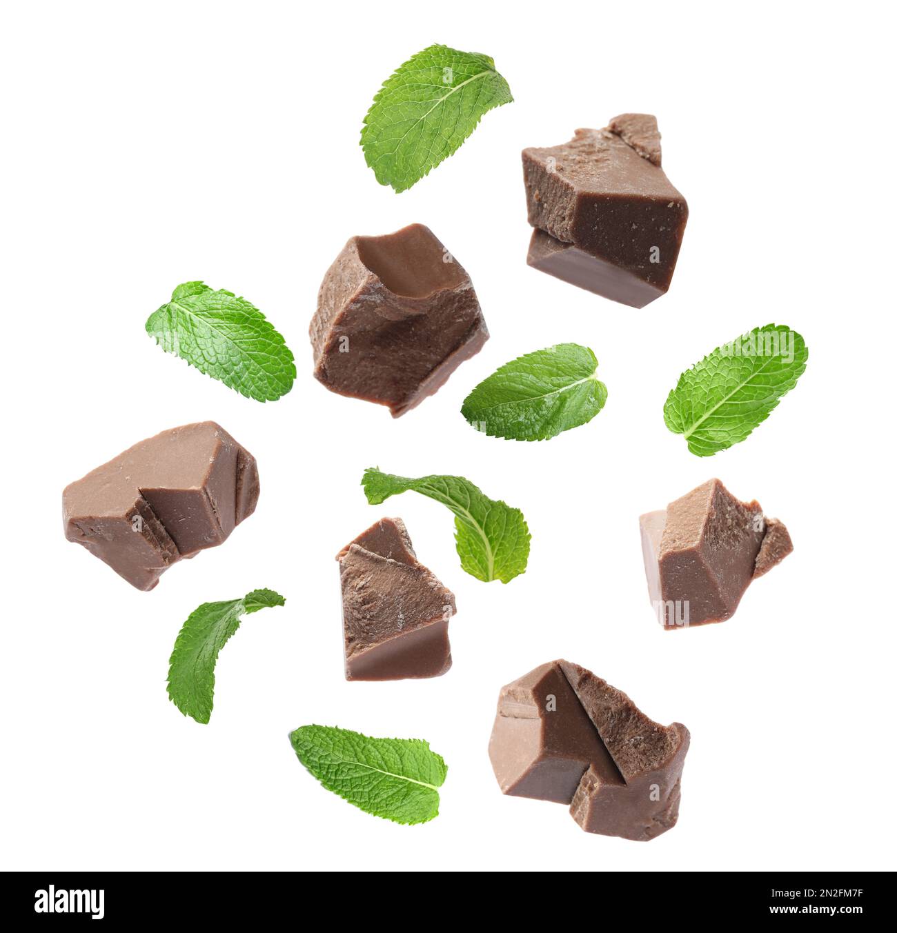 Milk chocolate pieces and mint falling on white background Stock Photo ...