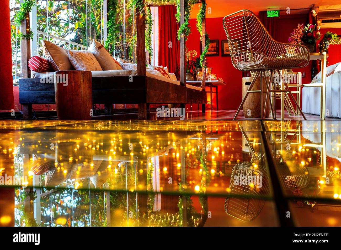 An interior of lounge hall in hot colors with a sofa and a wide window ...