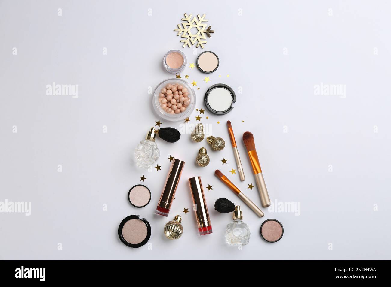 Christmas tree shape of decorative cosmetic products on light ...