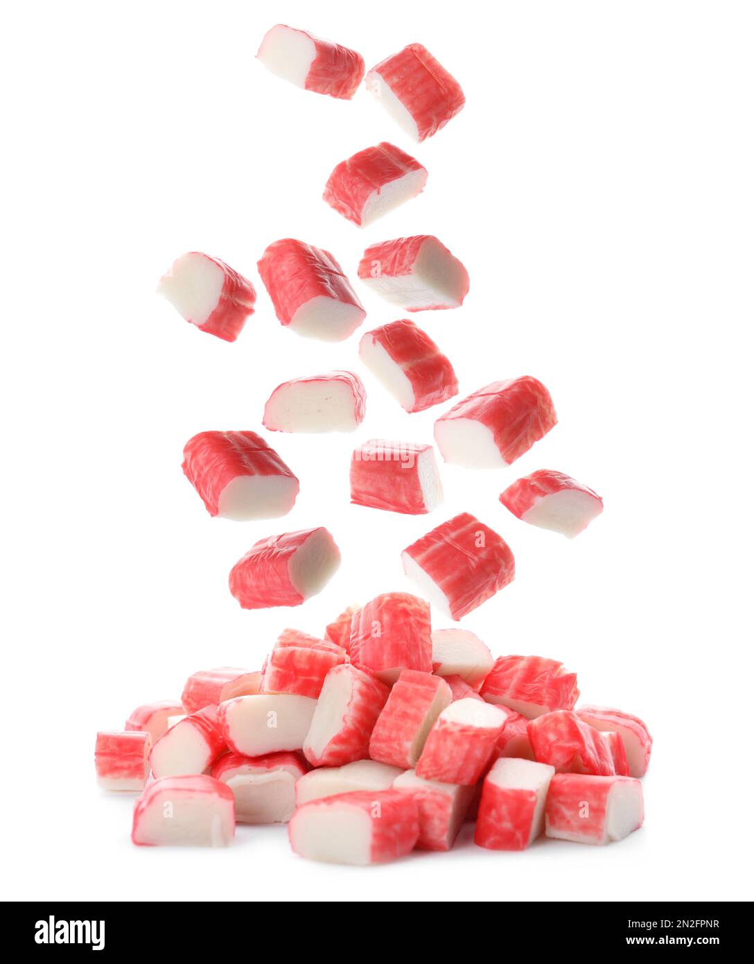 Cut fresh crab sticks falling on white background Stock Photo - Alamy
