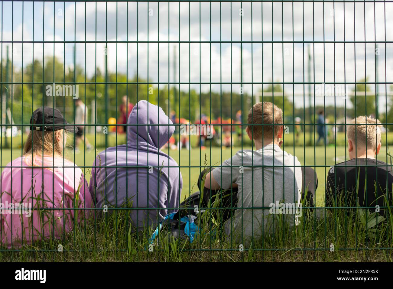 Children in stadium. Teenagers on sports field. Schoolchildren sit on ...