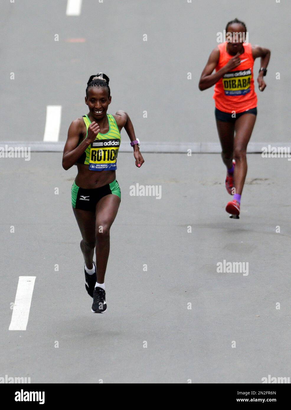 Caroline Rotich, of Kenya, leads Mare Dibaba, of Ethiopia, as they near ...