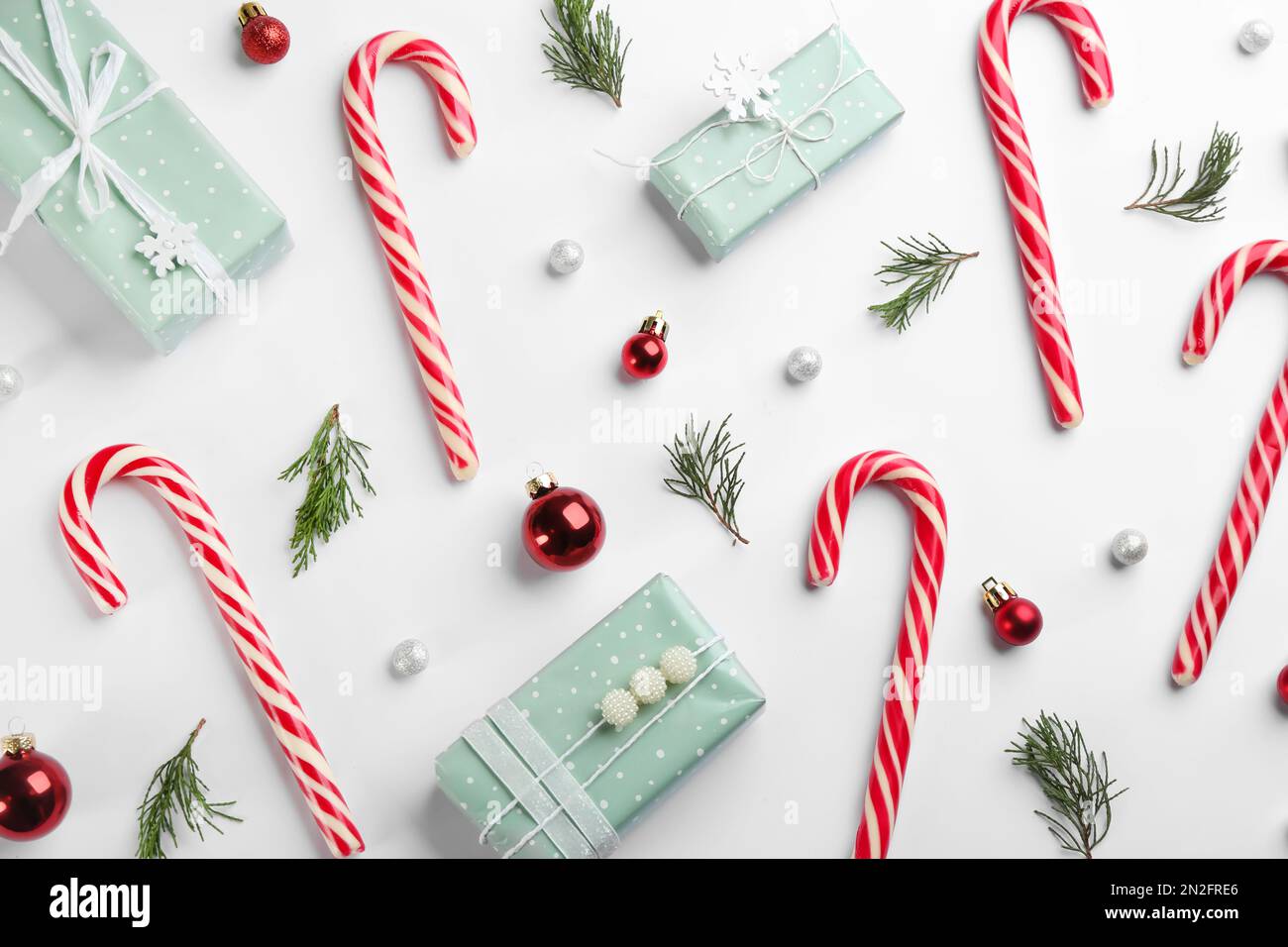 Flat lay composition with candy canes and Christmas decor on white ...