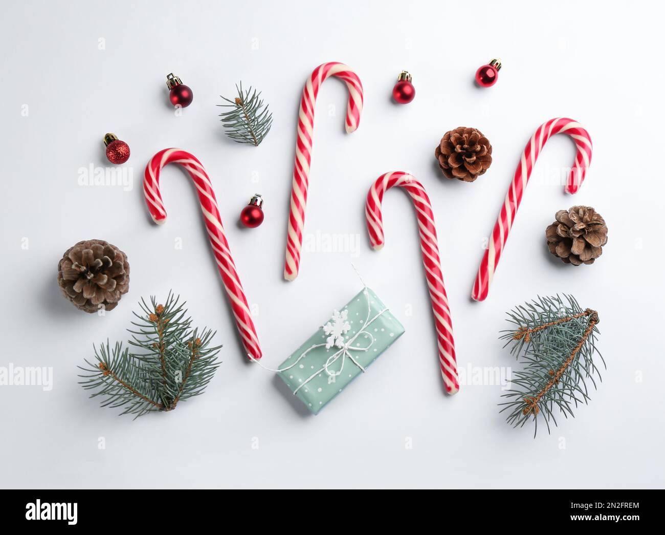 Flat lay composition with candy canes and Christmas decor on white background Stock Photo - Alamy