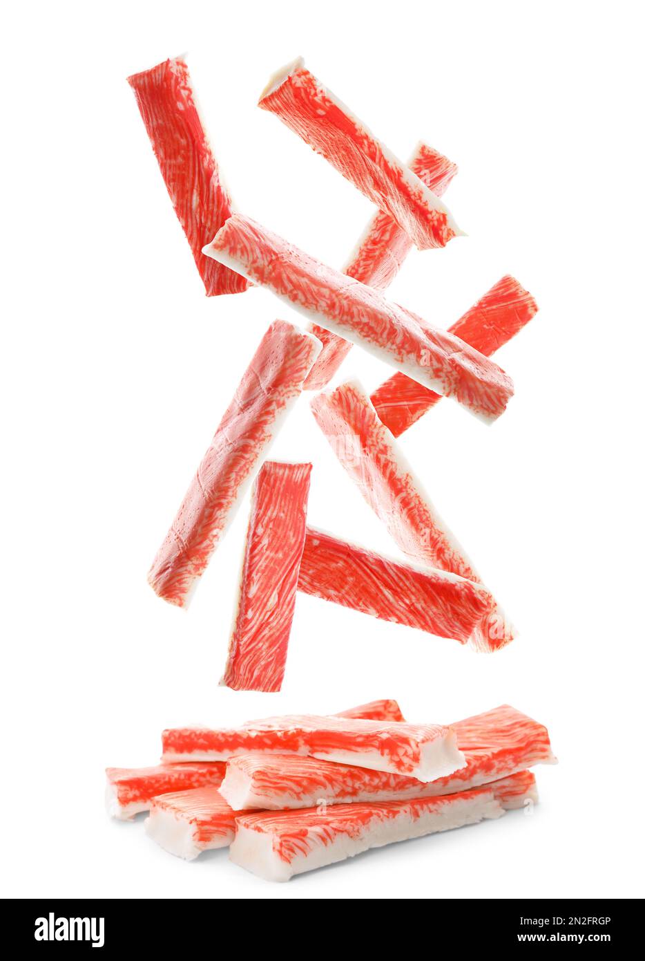 Many fresh crab sticks falling on white background Stock Photo - Alamy