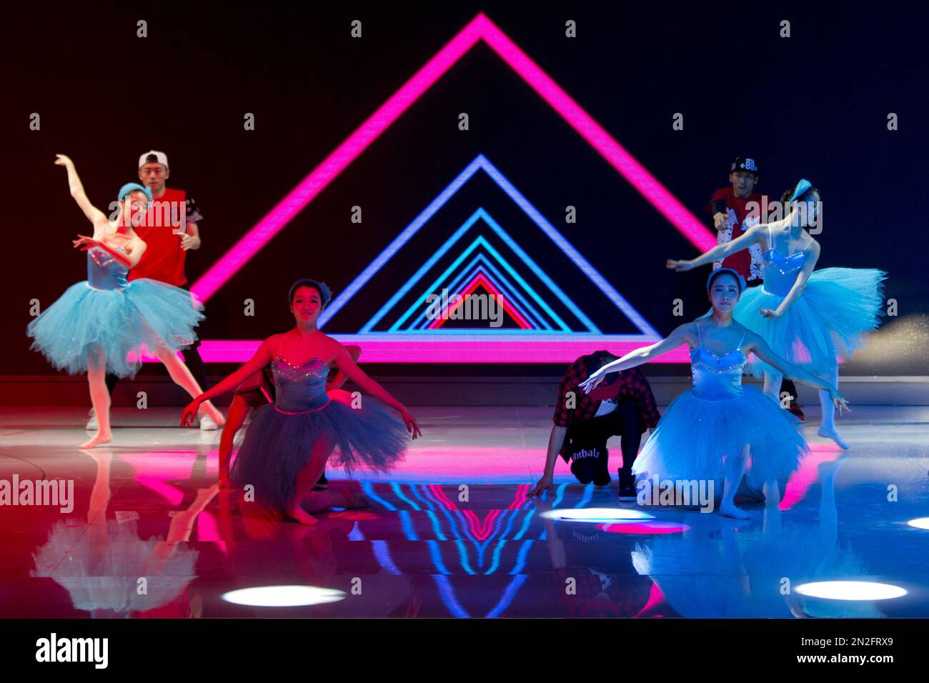 Dancers introduce the latest car from Japanese automaker Toyota at the ...