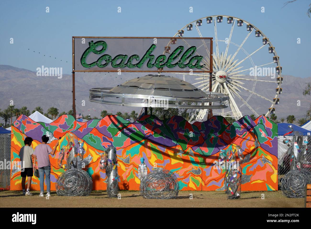 Festival-goers view the "Coachella Bound" art installation at the ...
