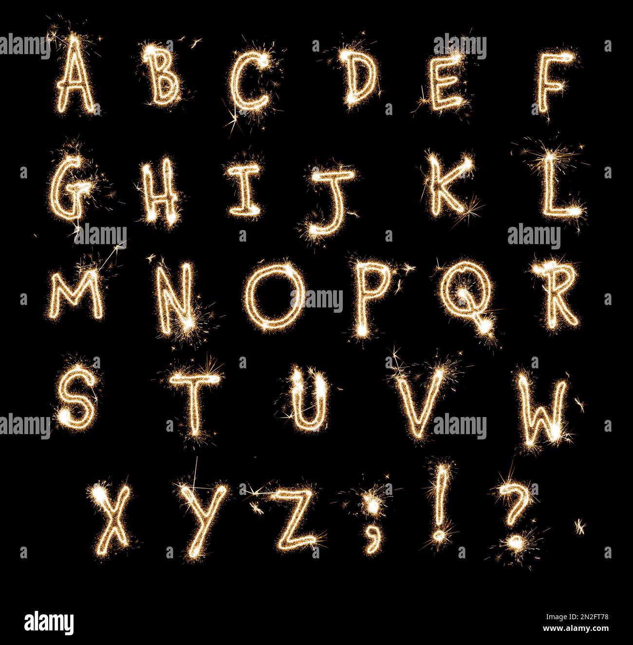 Set with letters made of sparkler on black background Stock Photo - Alamy