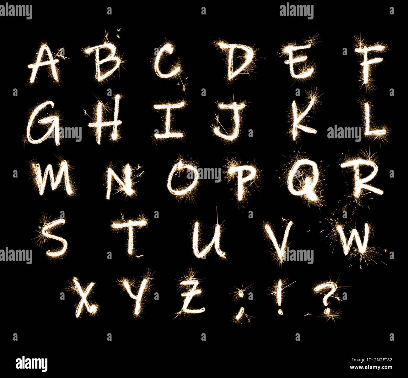 Set with letters made of sparkler on black background Stock Photo - Alamy