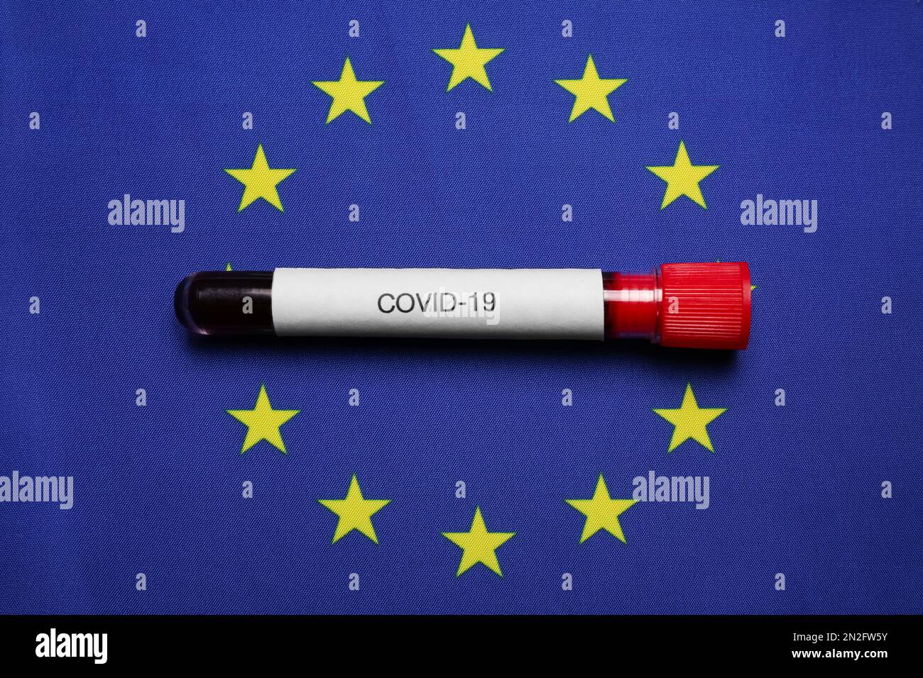 Test tube with blood sample on European Union flag background, top view ...